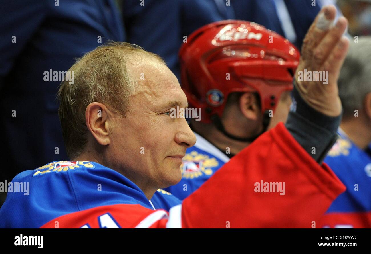 Russian President Vladimir Putin waves during the Night Hockey League ...
