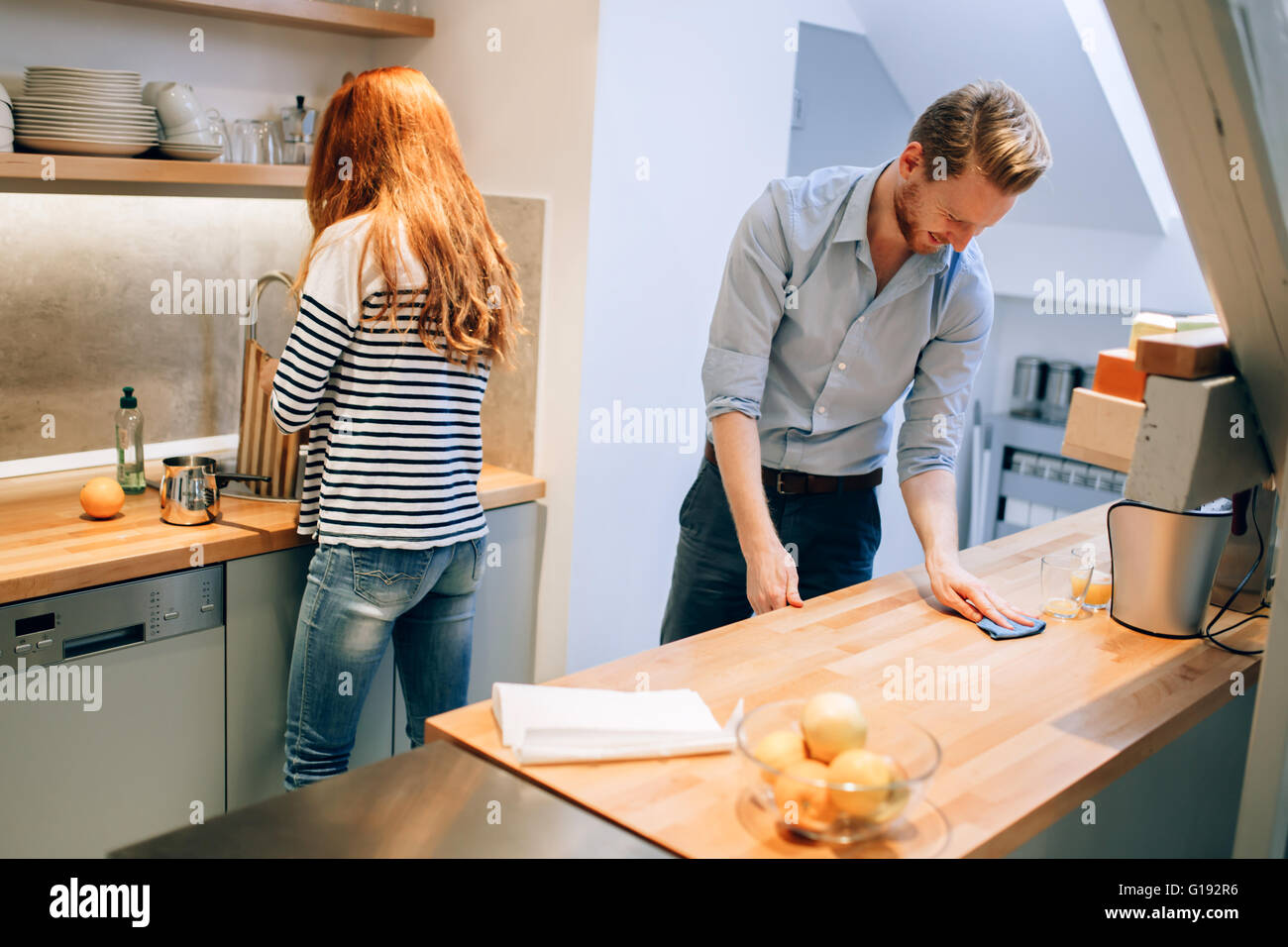 Couple team working in kitchen and sharing household chores Stock Photo ...