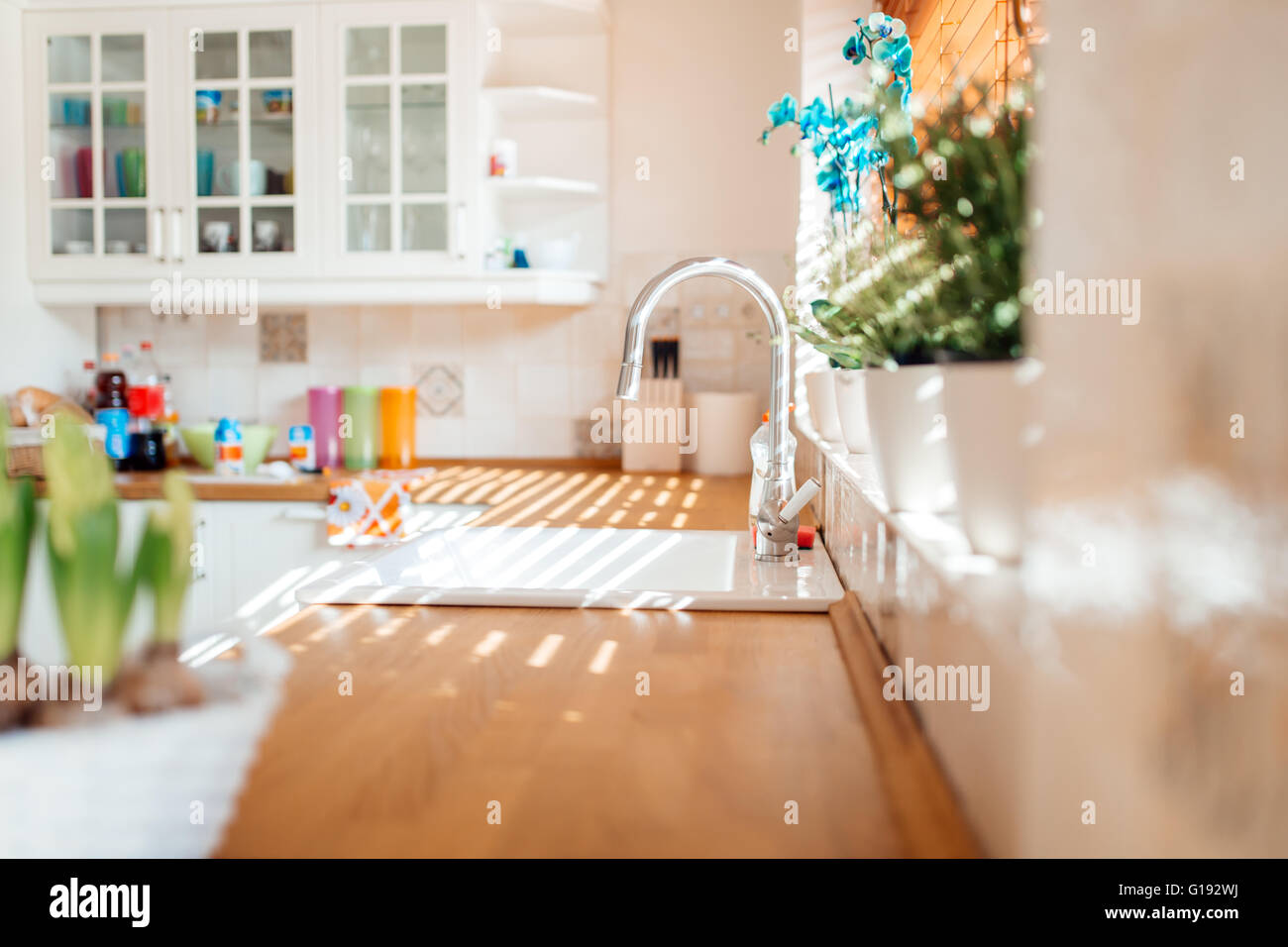 Modern white kitchen sink with morning sun rays Stock Photo - Alamy