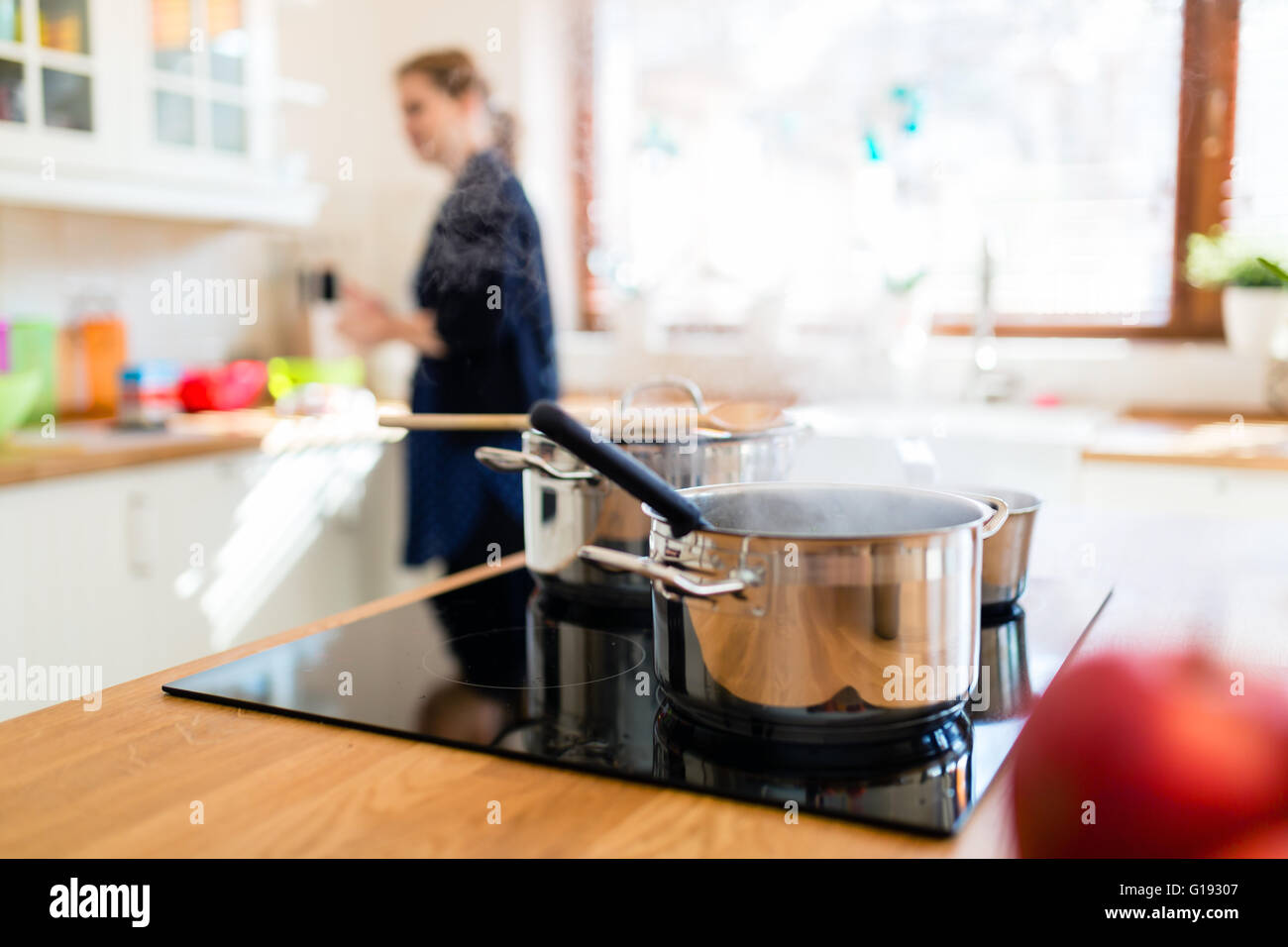 Housewife making lunch in modern kitchen Stock Photo - Alamy