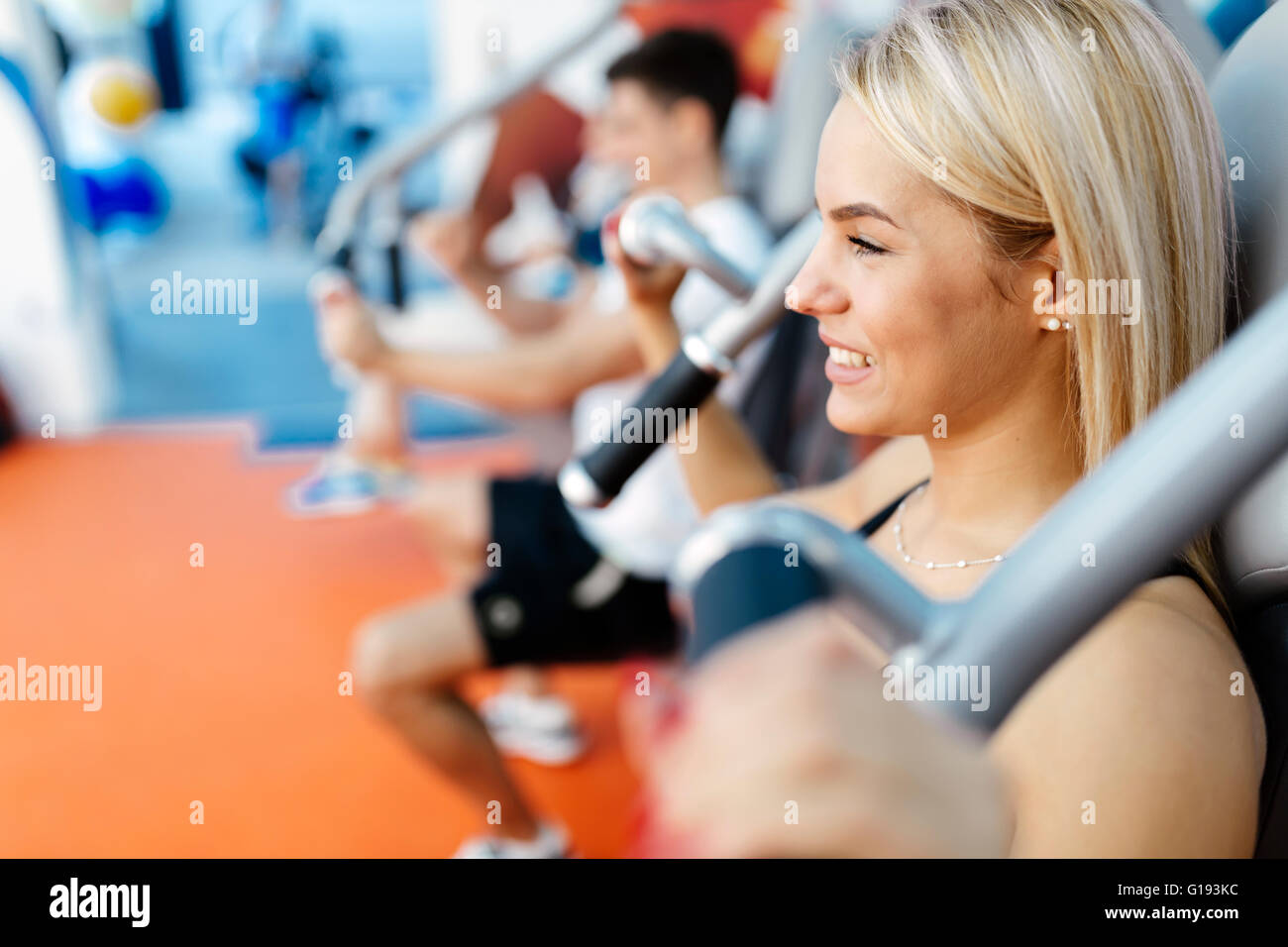 People exercising in gym on various machines Stock Photo - Alamy