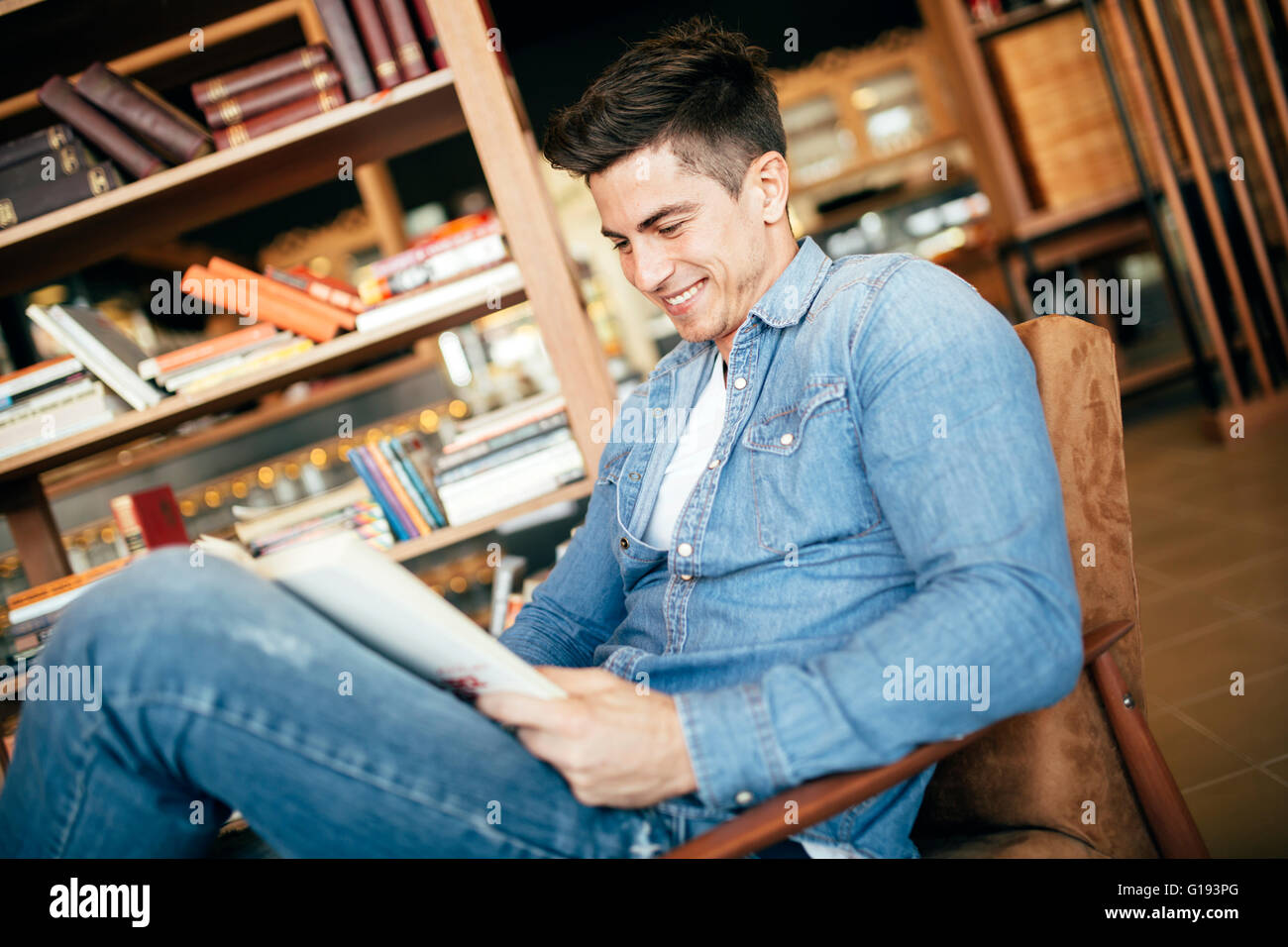 Handsome man studying by reading books and preparing for exam Stock ...
