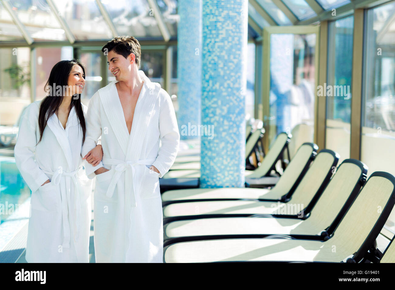 Couple in love standing next to a pool in a robe and relaxing Stock ...