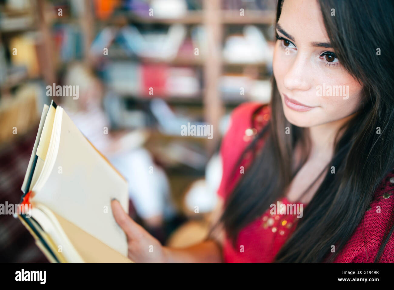 Beautiful woman reading book and preparing for exam Stock Photo - Alamy