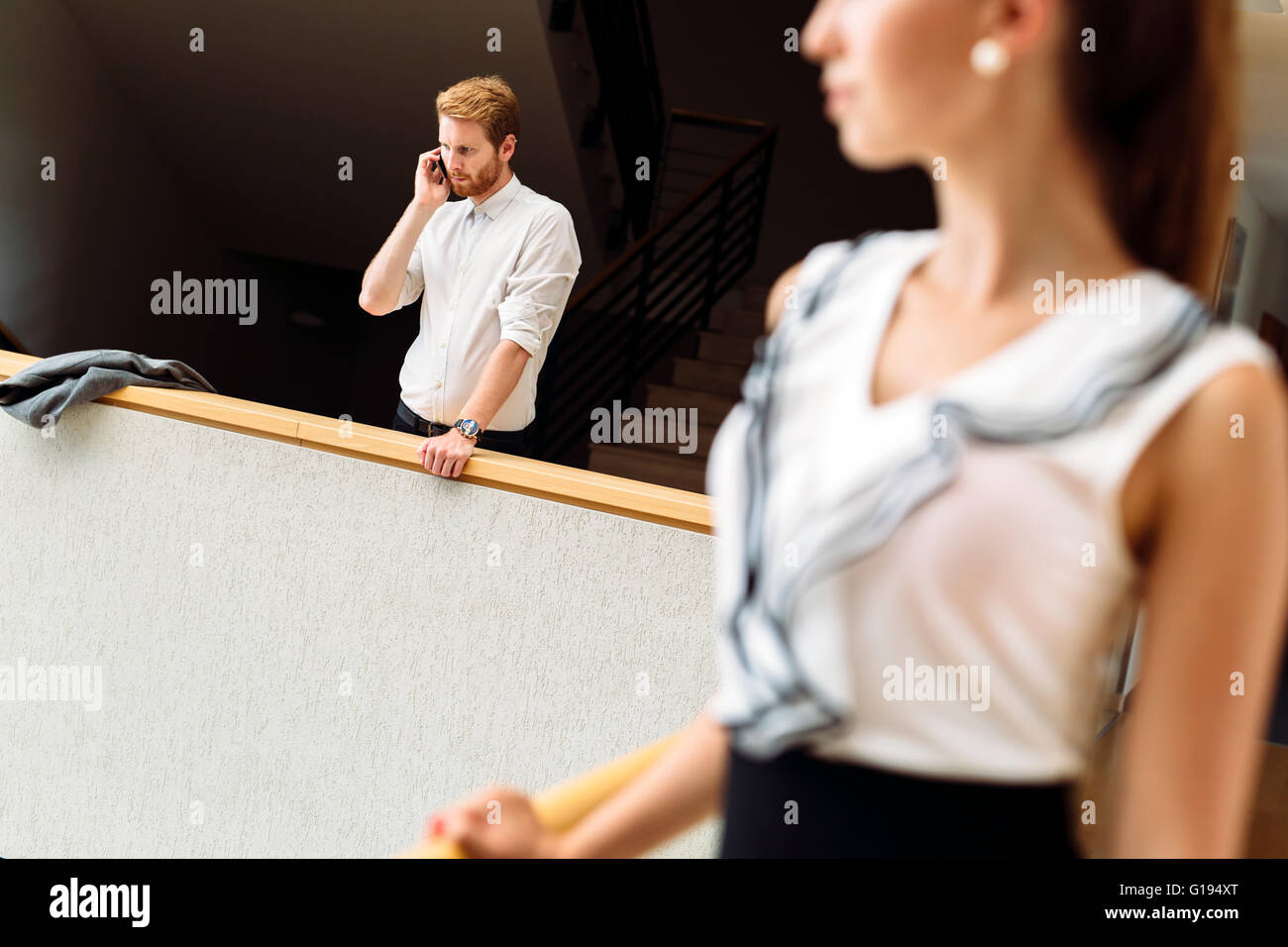 Businessman using phone while having a break Stock Photo - Alamy