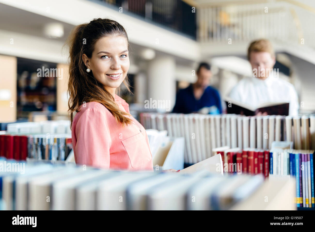 Beautiful student studyin in library Stock Photo - Alamy