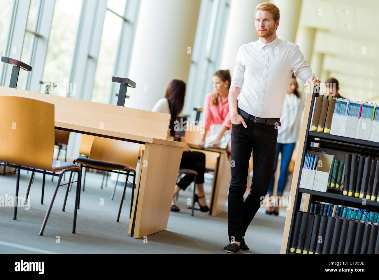 Group of smart young people educating themselves in a library Stock ...