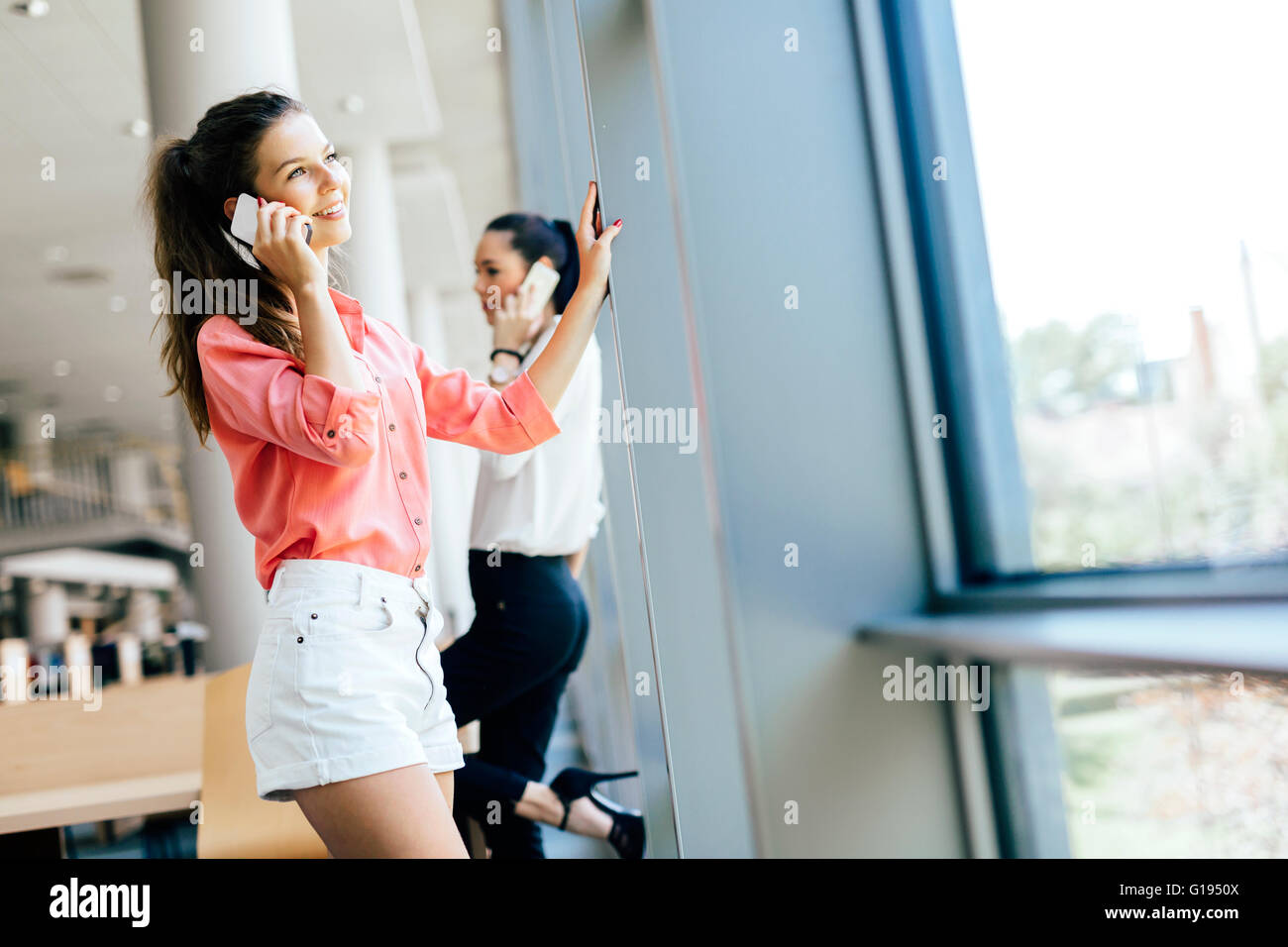 Beautiful women, colleagues using phones and talkin during break Stock ...