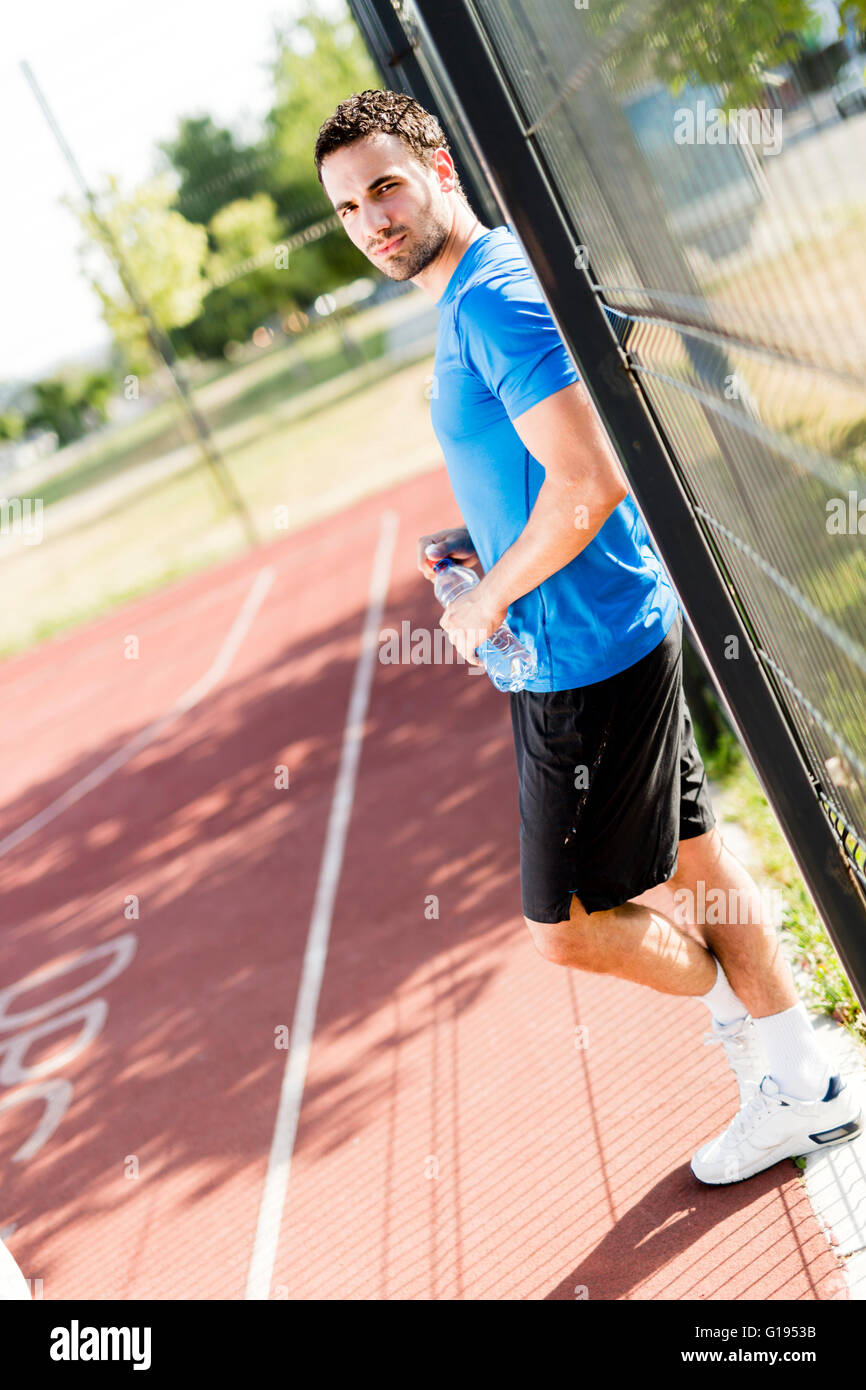 Young athlete taking a break from exercising on a hot summer day Stock ...