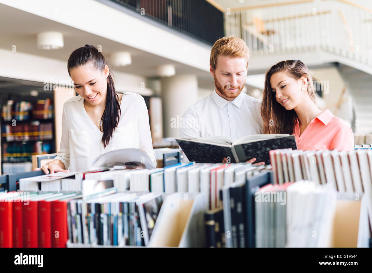 Group of students studying in library and reading books Stock Photo - Alamy