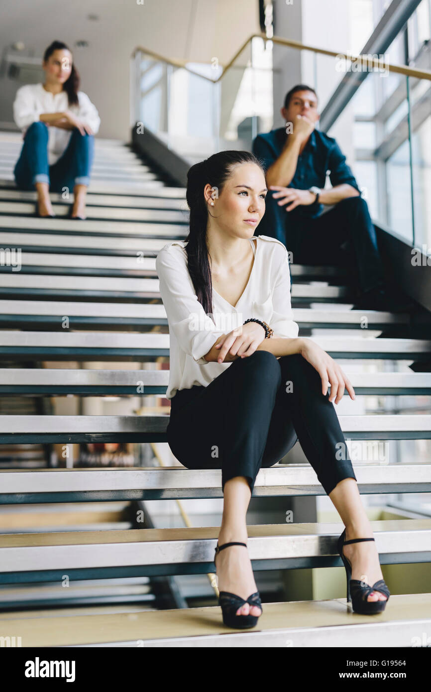 Business people sitting on stairs and thinking. Modern enterior Stock ...