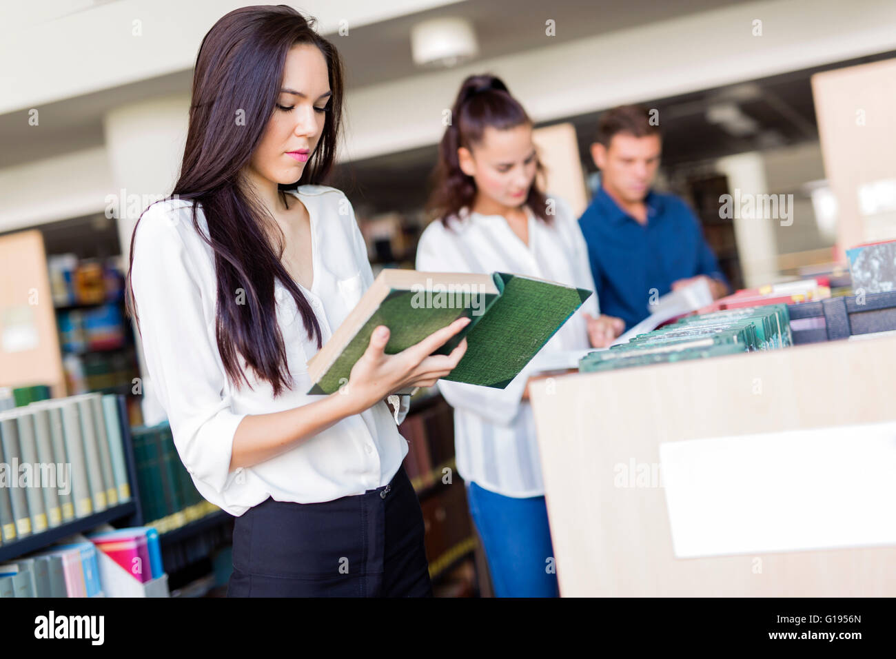 Smart students reading and studying in library whole searching through ...