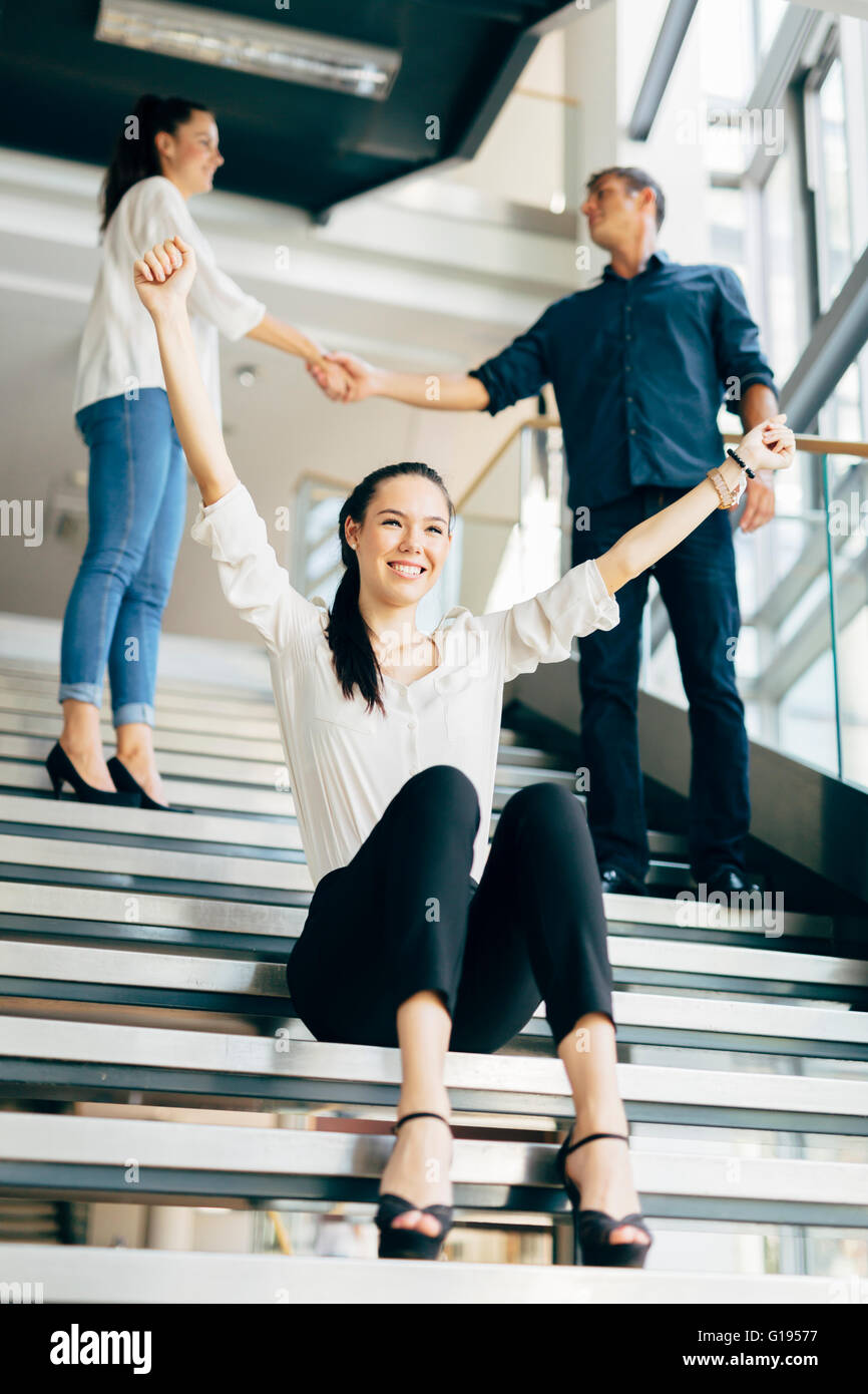 Group of business people shaking hands on stairs in a beautiful modern ...