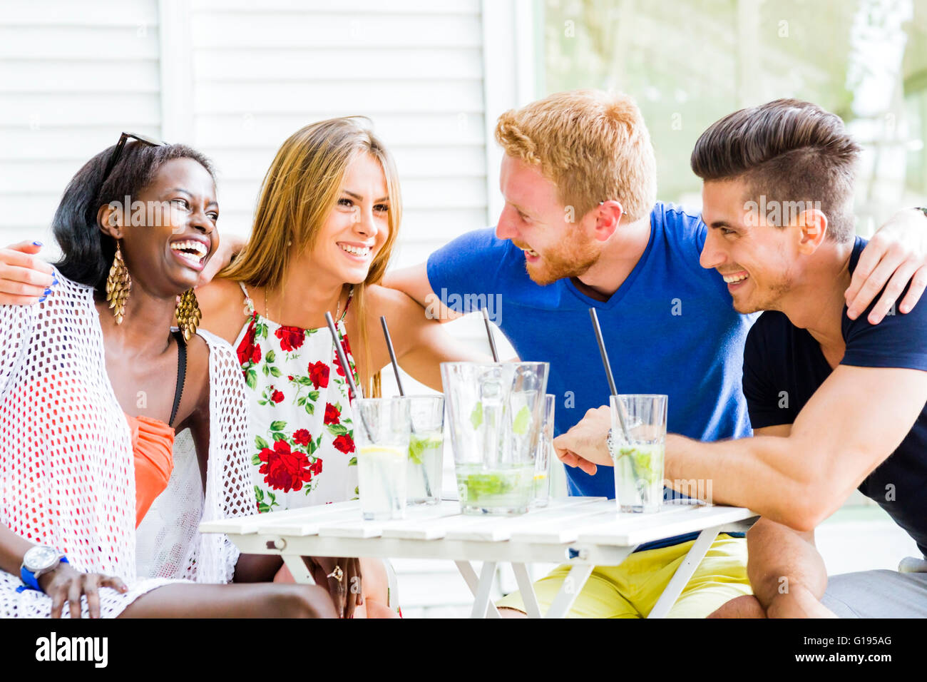 Friends laughing and hugging each outher outdoors and being happy Stock ...