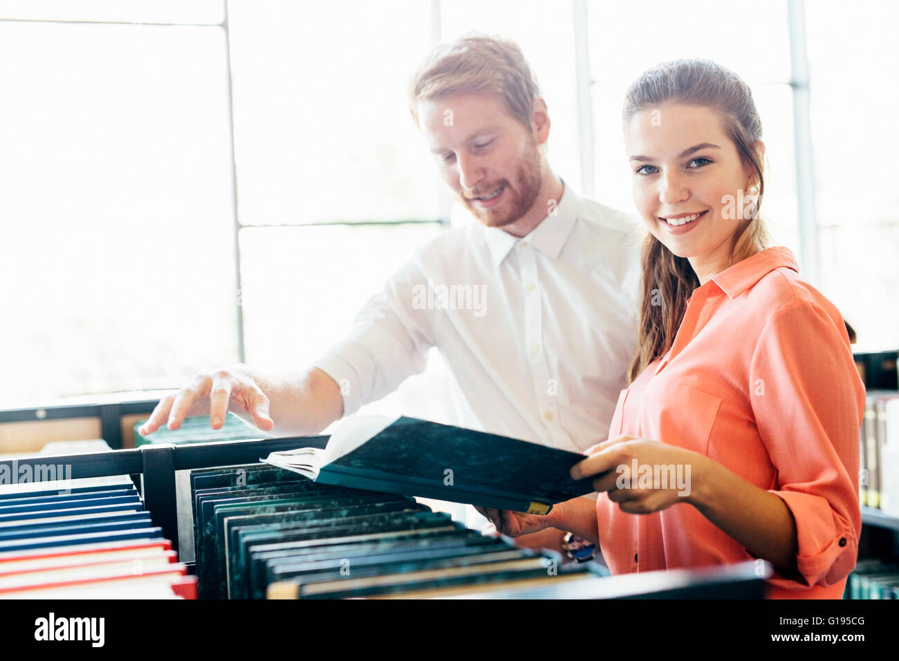 Two smart students reading and studying in library whole searching ...