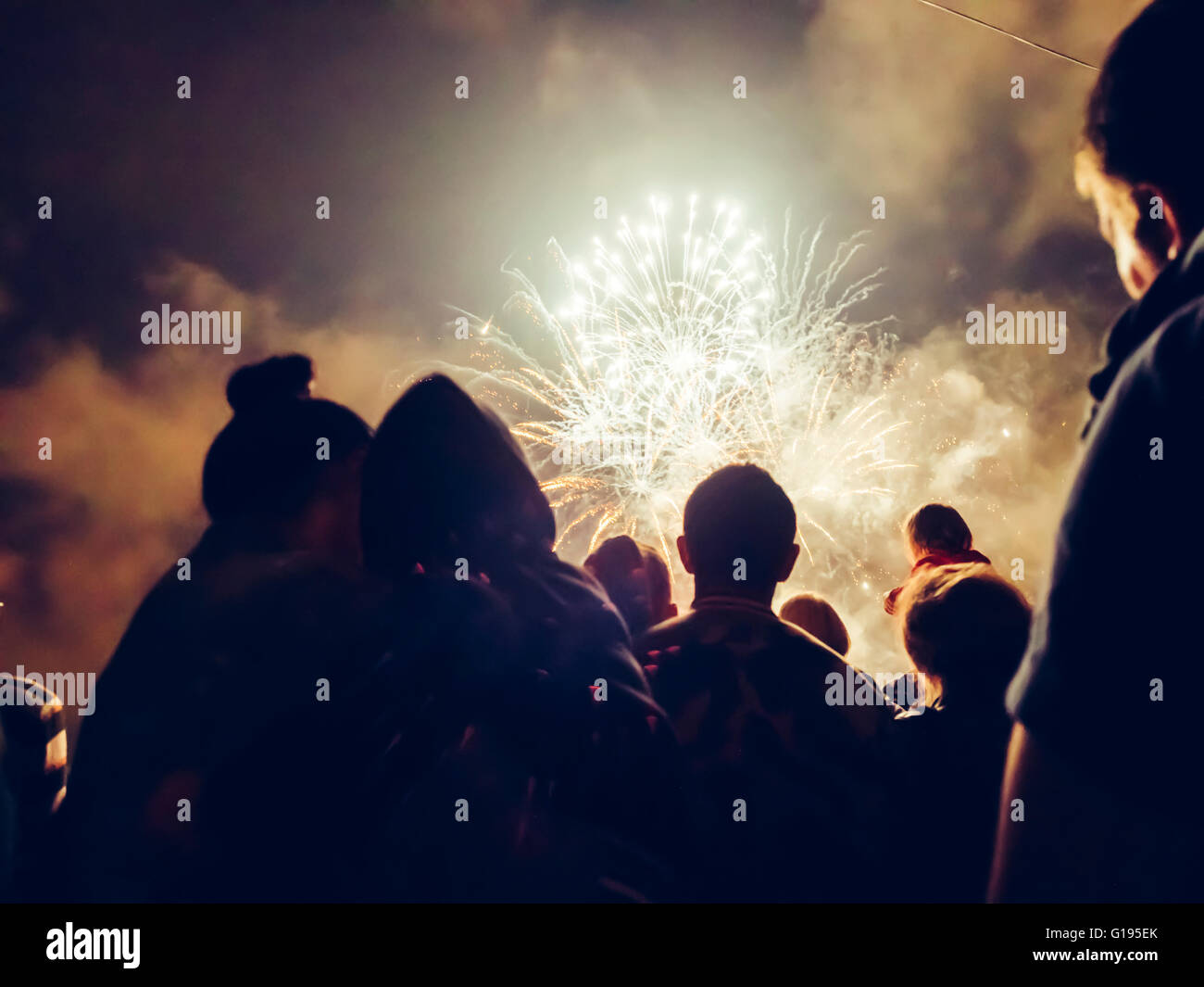 Crowd wathcing fireworks and celebrating Stock Photo - Alamy