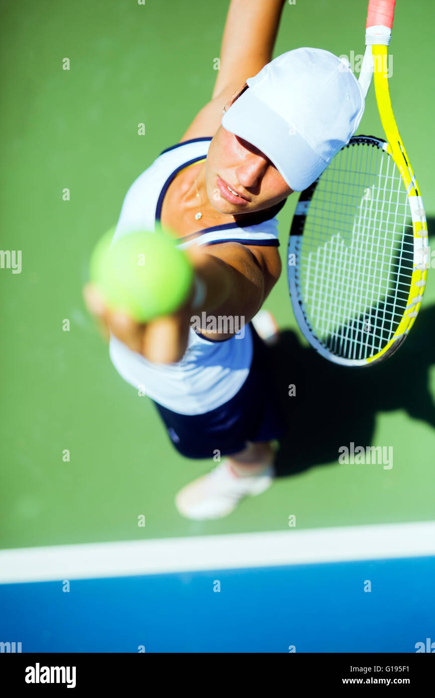 Beautiful female tennis player serving outdoor and a closeup of the ...