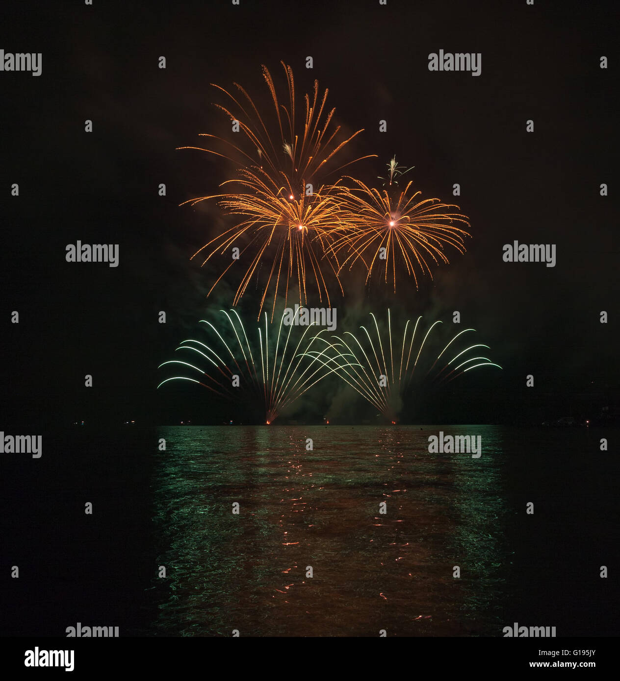 Colorful fireworks with reflection on lake and night sky in background ...
