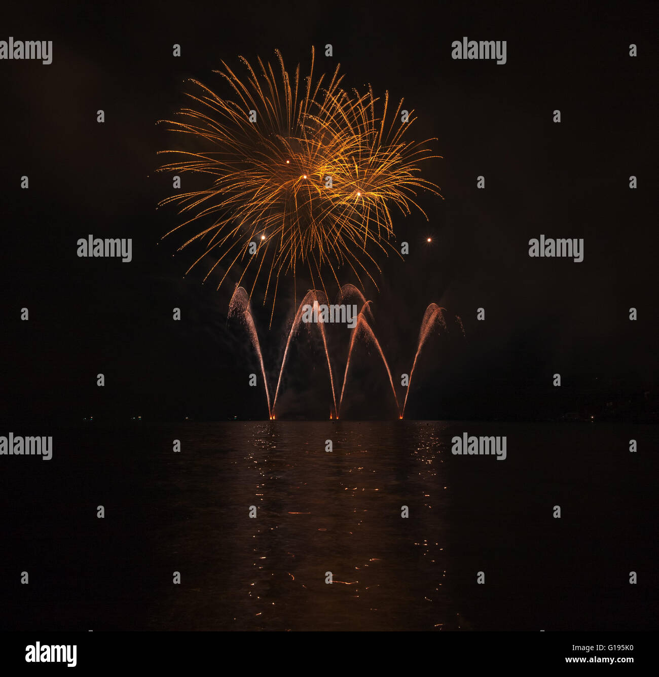 Colorful fireworks with reflection on lake and night sky in background ...