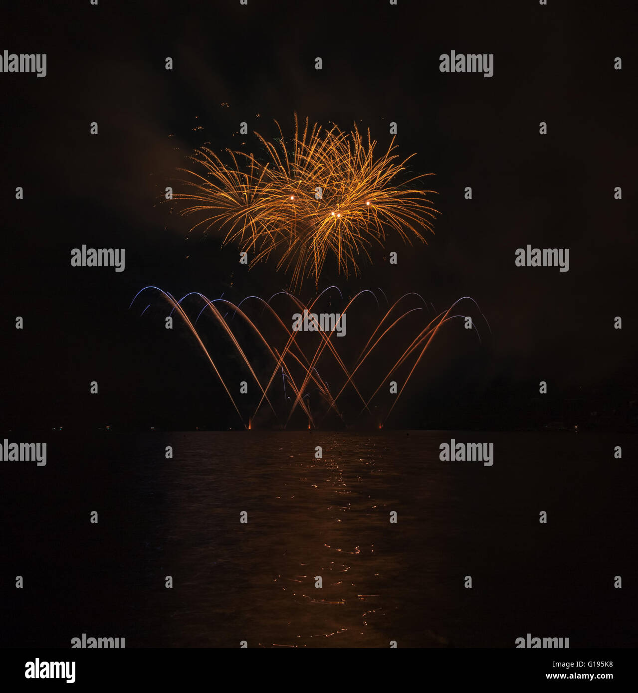 Colorful fireworks with reflection on lake and night sky in background ...