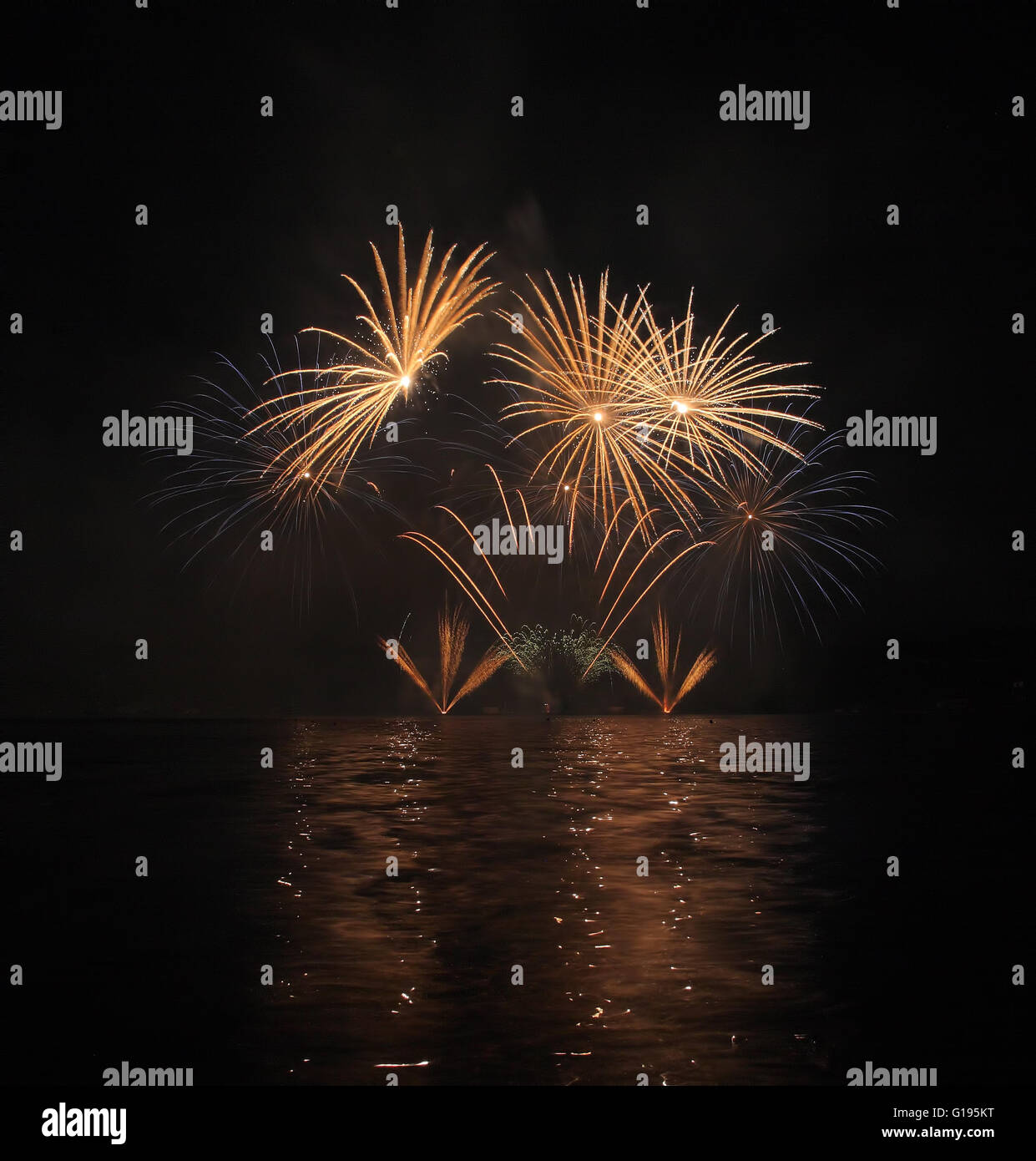 Colorful fireworks with reflection on lake and night sky in background ...