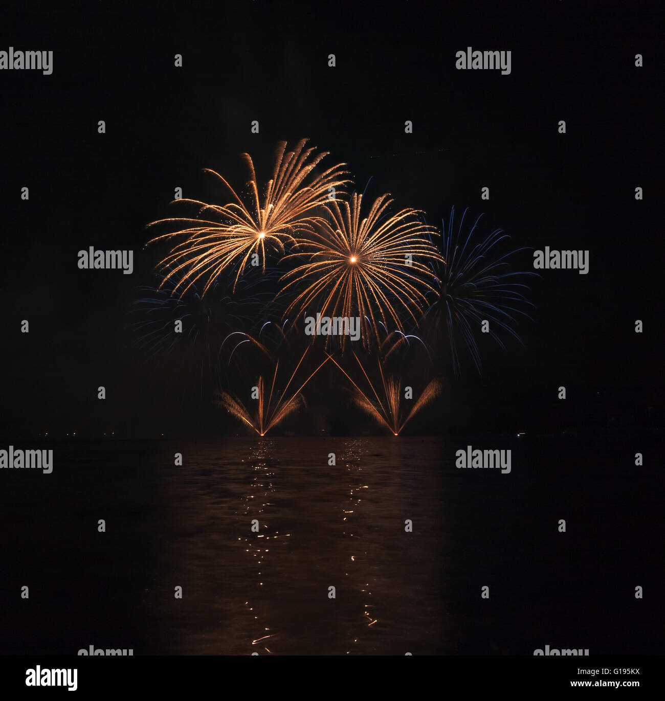 Colorful fireworks with reflection on lake and night sky in background ...