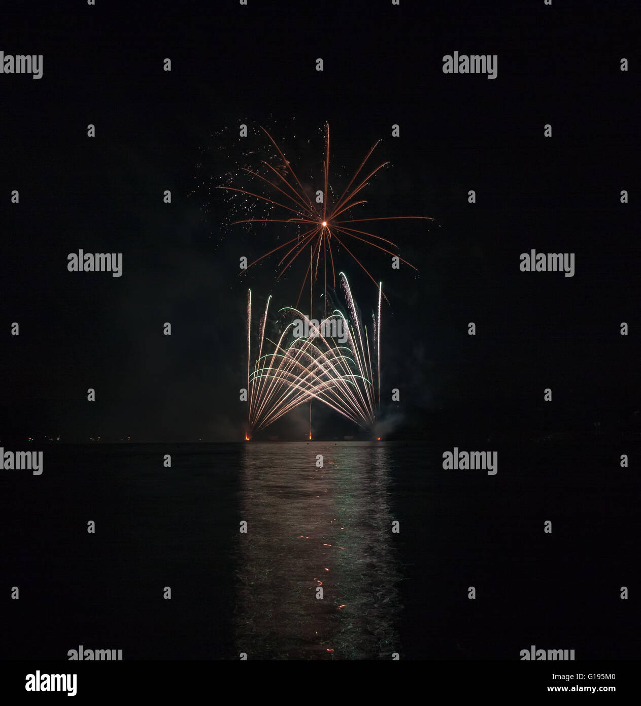 Colorful fireworks with reflection on lake and night sky in background ...