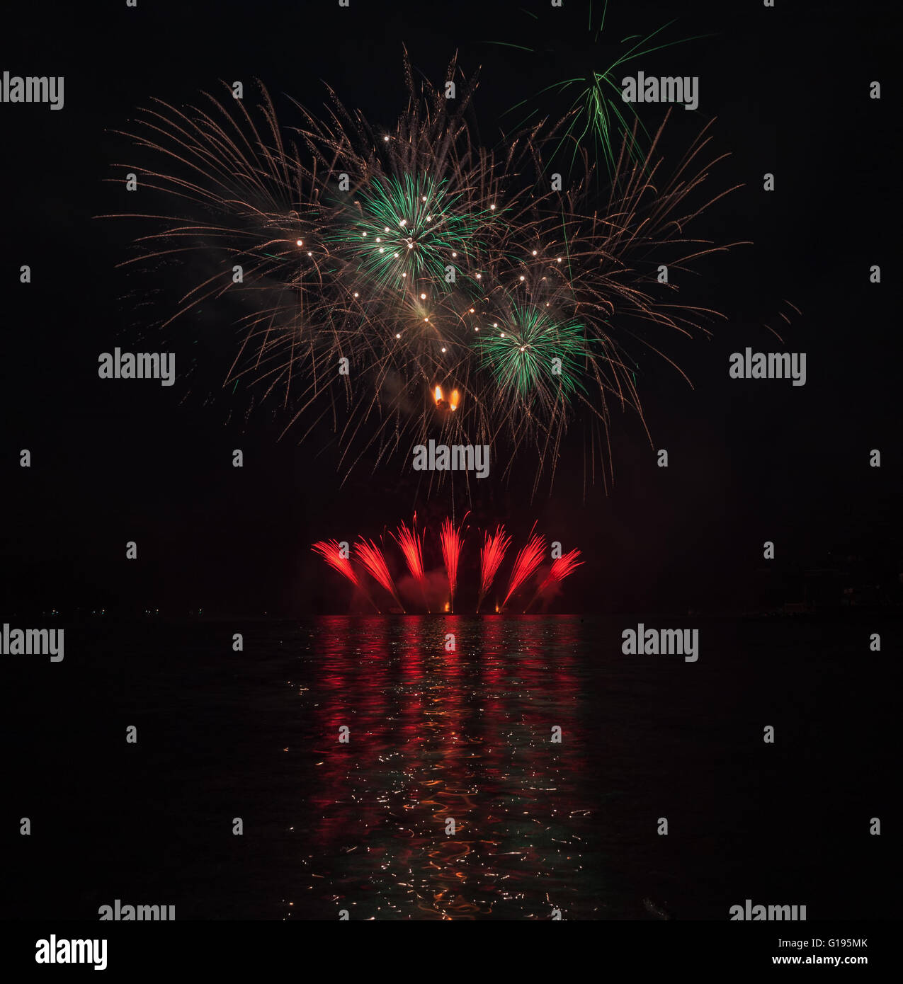 Colorful fireworks with reflection on lake and night sky in background ...