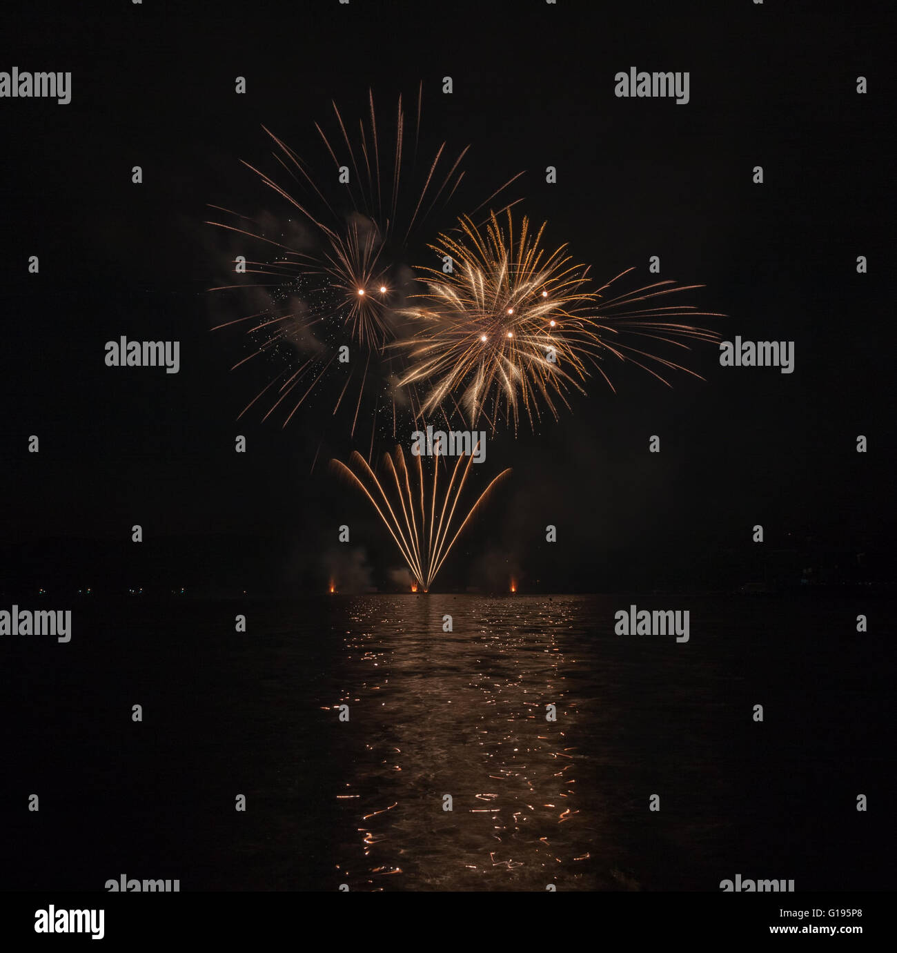 Colorful fireworks with reflection on lake and night sky in background ...