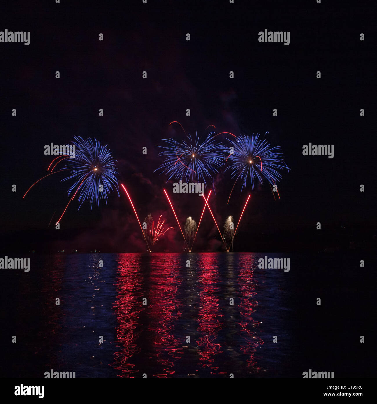 Colorful fireworks with reflection on lake and night sky in background ...