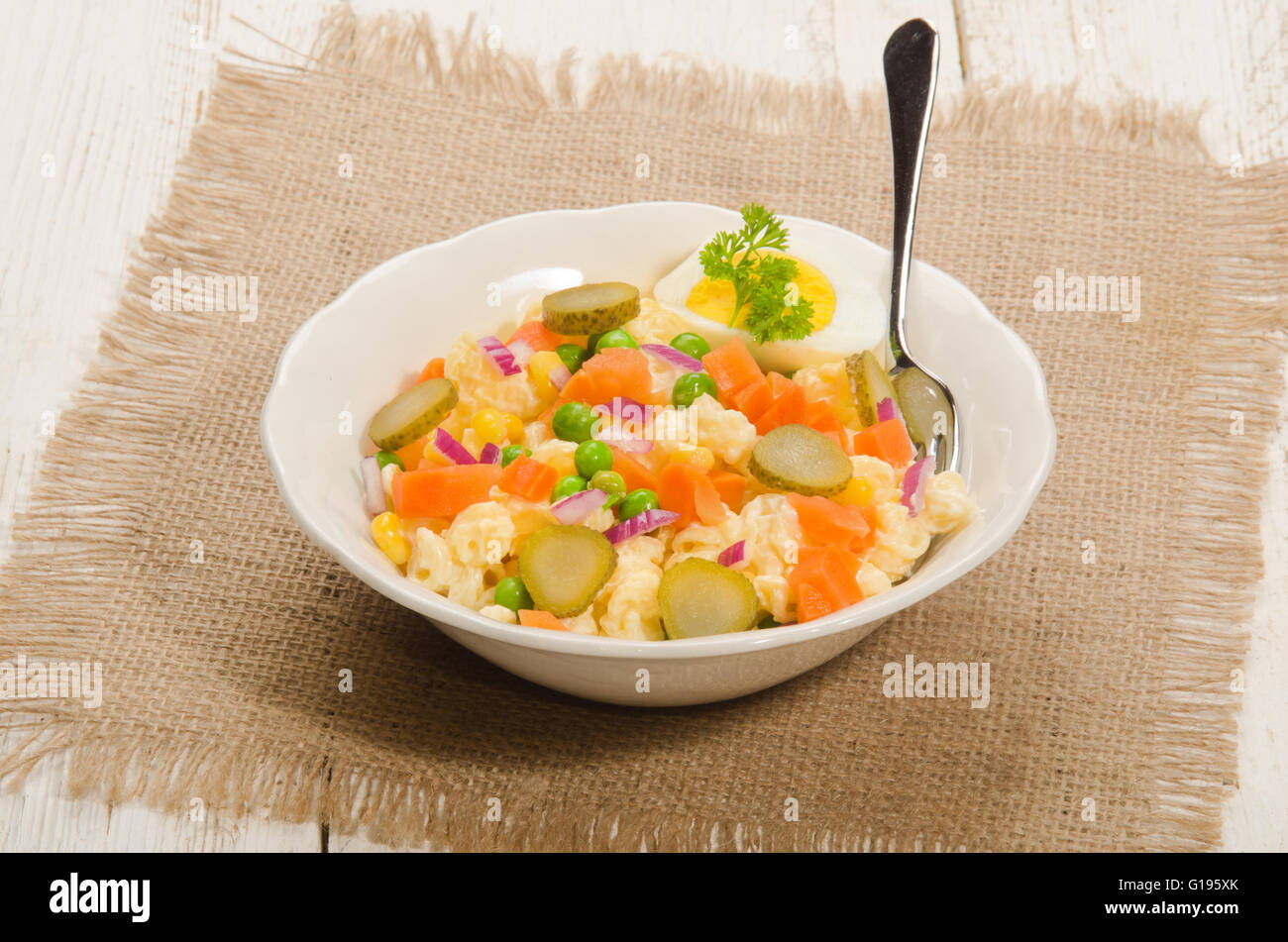 vegetable pasta salad with carrot, pea, lilac onion, egg, parsley and ...
