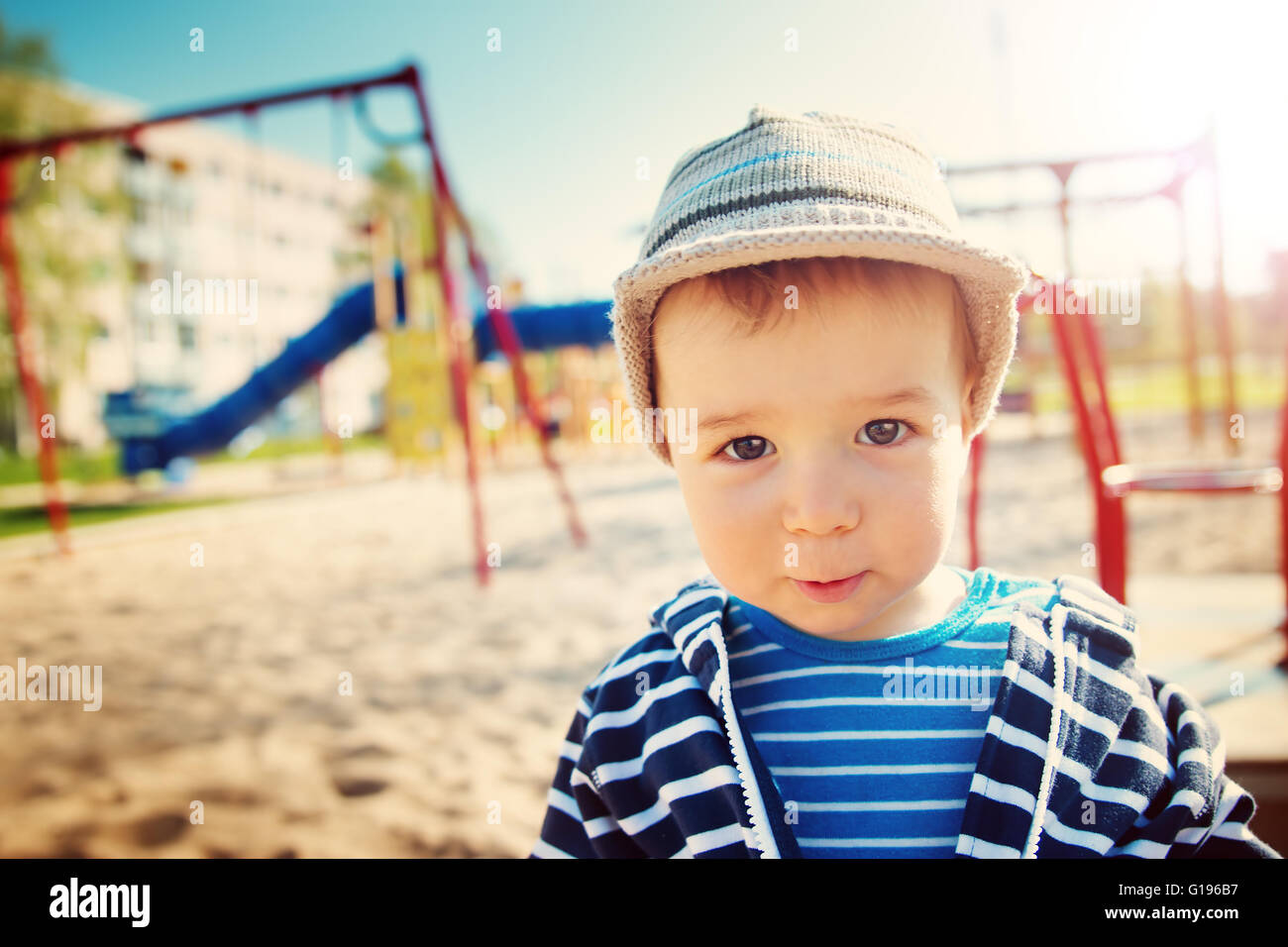 Little boy playing on playground Stock Photo - Alamy