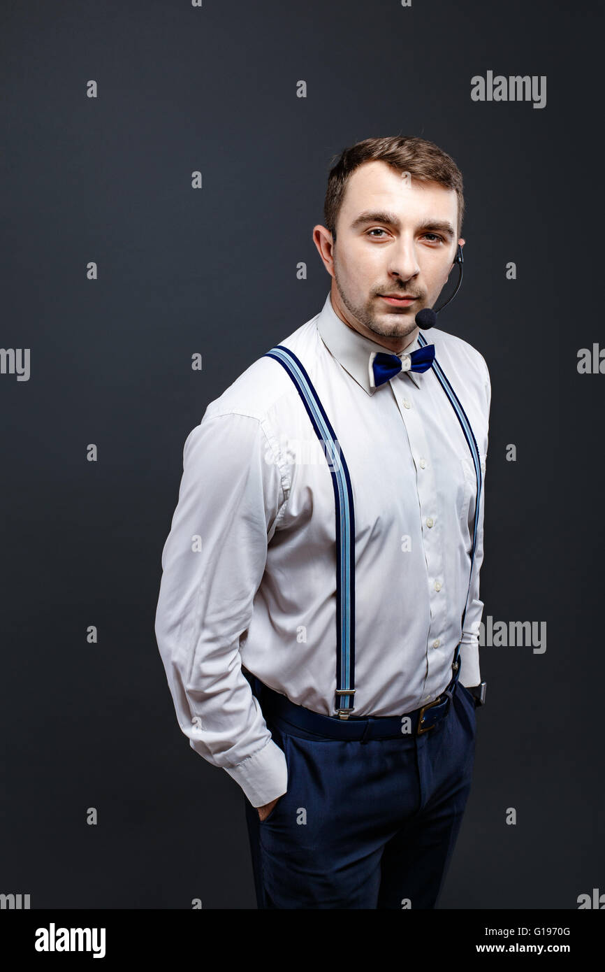 Portrait of stylish man in suspenders and bow-tie Stock Photo - Alamy