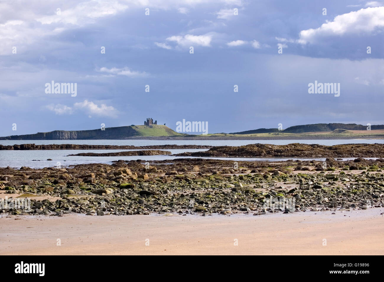 Dunstanburgh castle from beach of embleton bay Stock Photo - Alamy