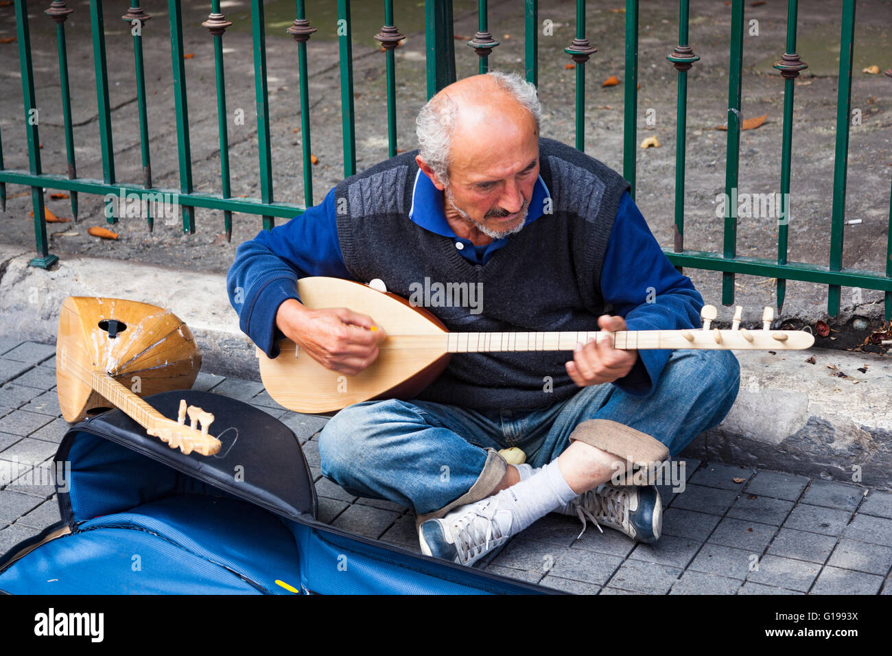 Street musician playing a stringed musical instrument, Istanbul, Turkey ...