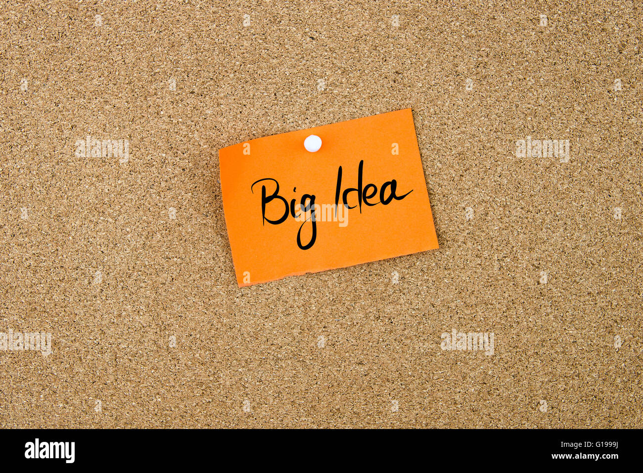 Big Idea written on orange paper note pinned on cork board with white ...