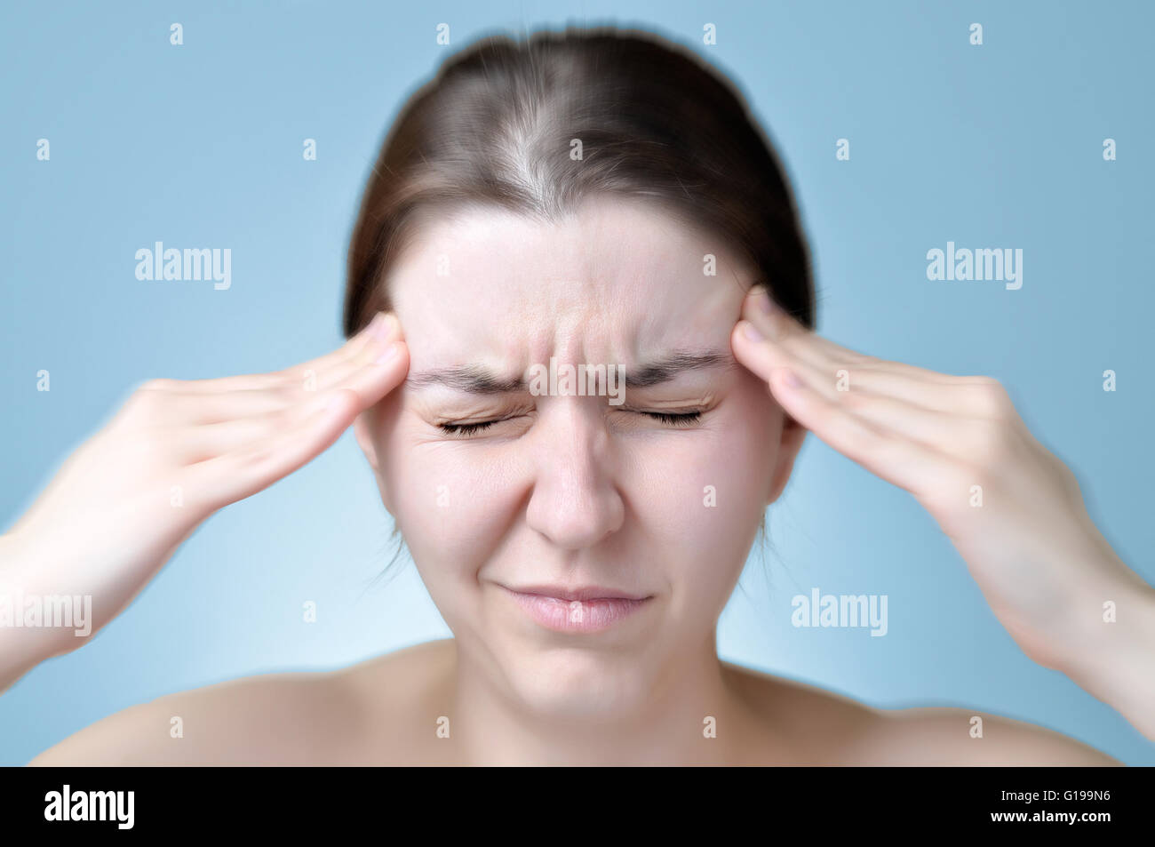 Young woman touching her head Stock Photo - Alamy