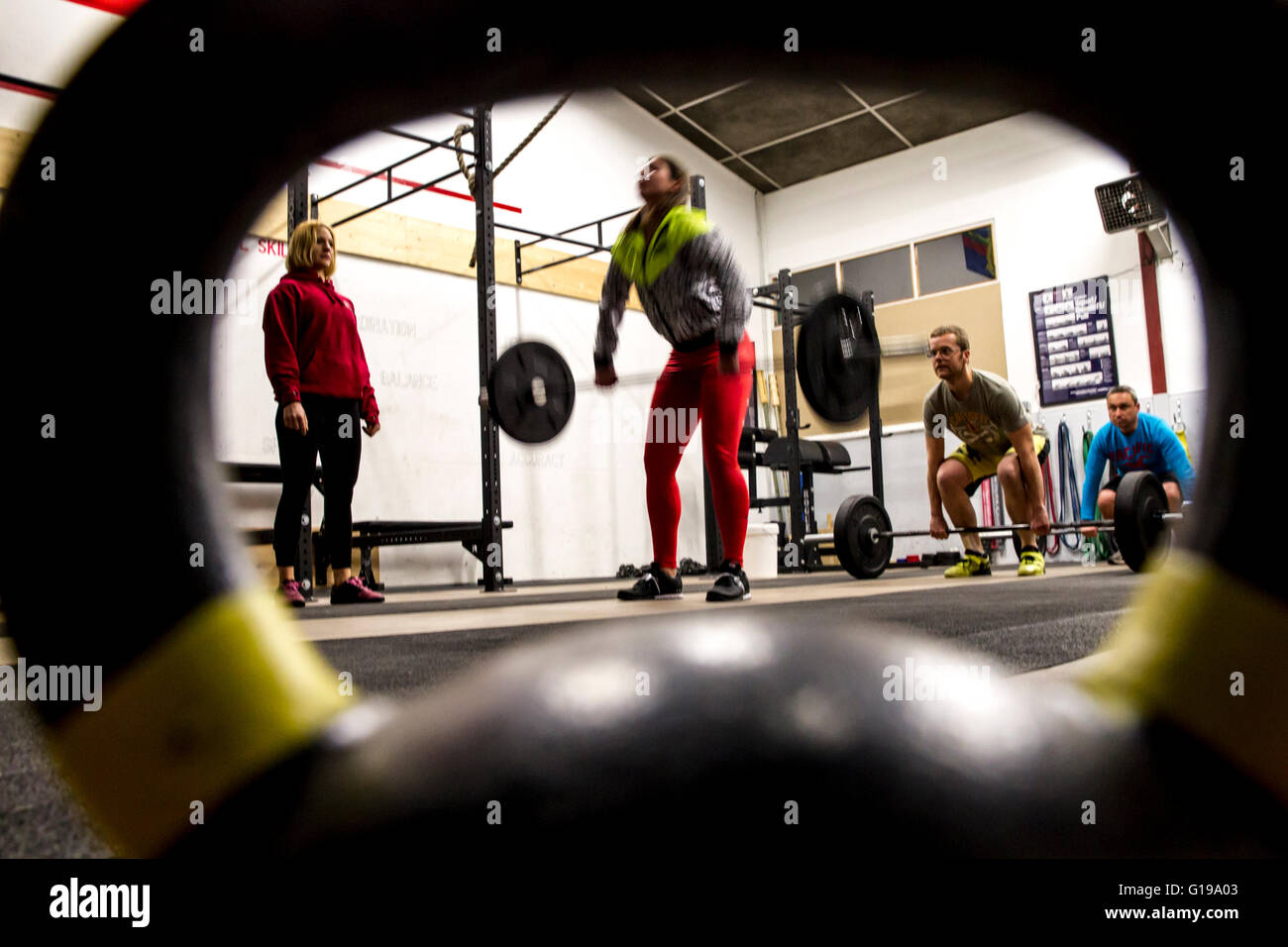 Female lifting weights under the supervision of the coach Stock Photo ...