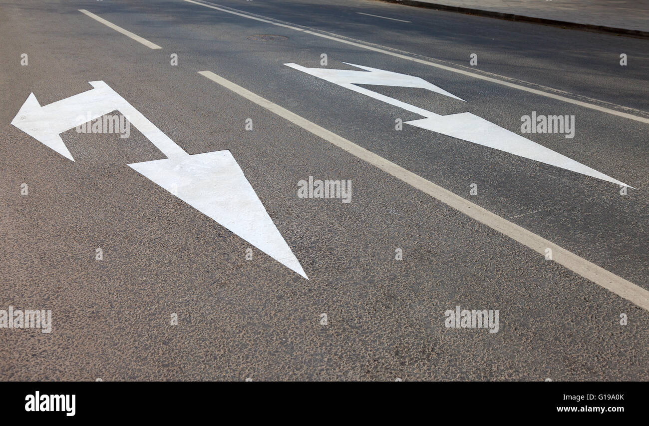 Road with white marking lines and direction of motion on asphalt Stock ...