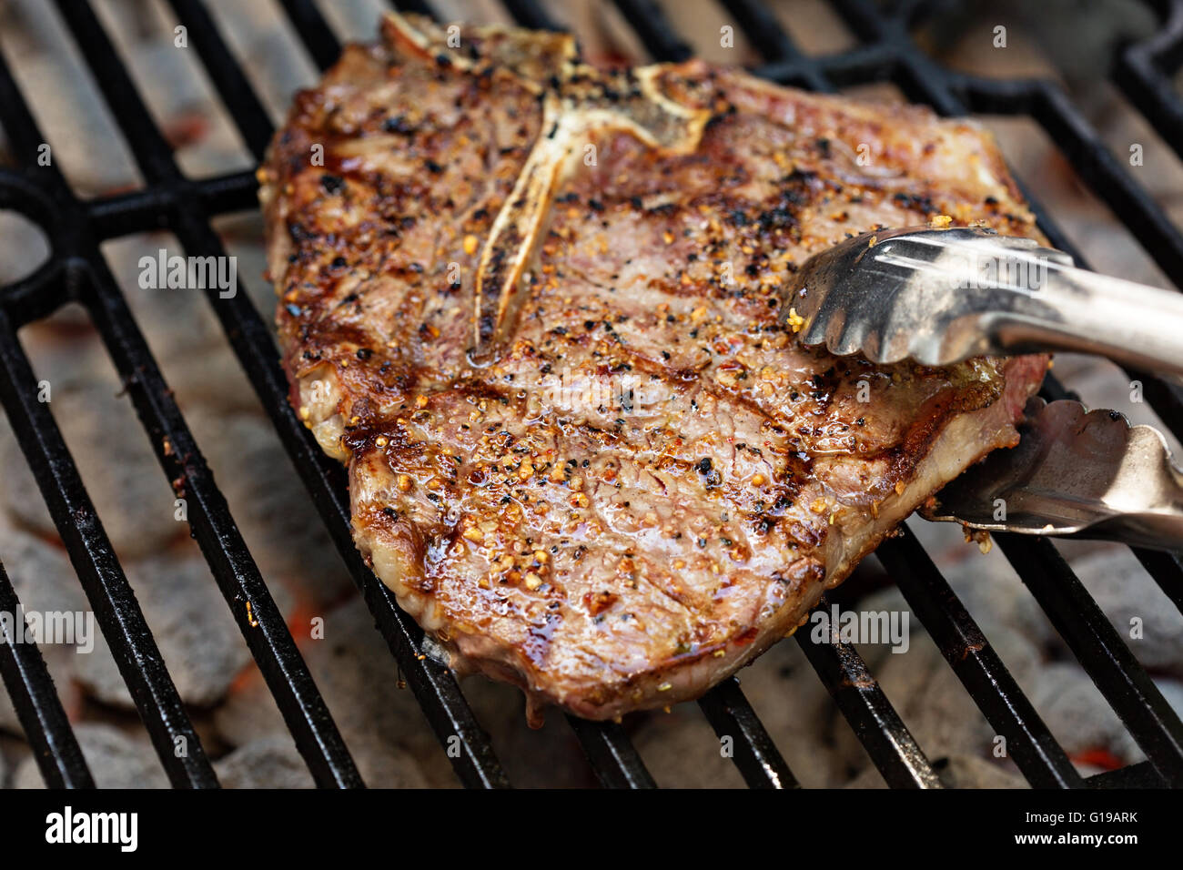 Beef steak being cooked on a grill Stock Photo - Alamy
