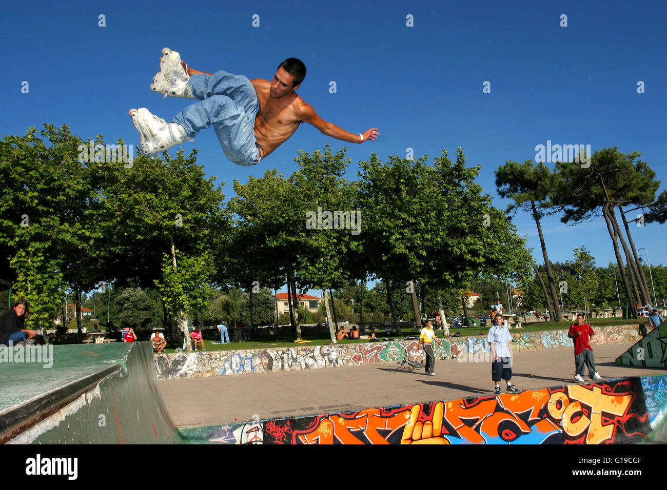 young boy practicing with their skates in Vigo park by the sea ...
