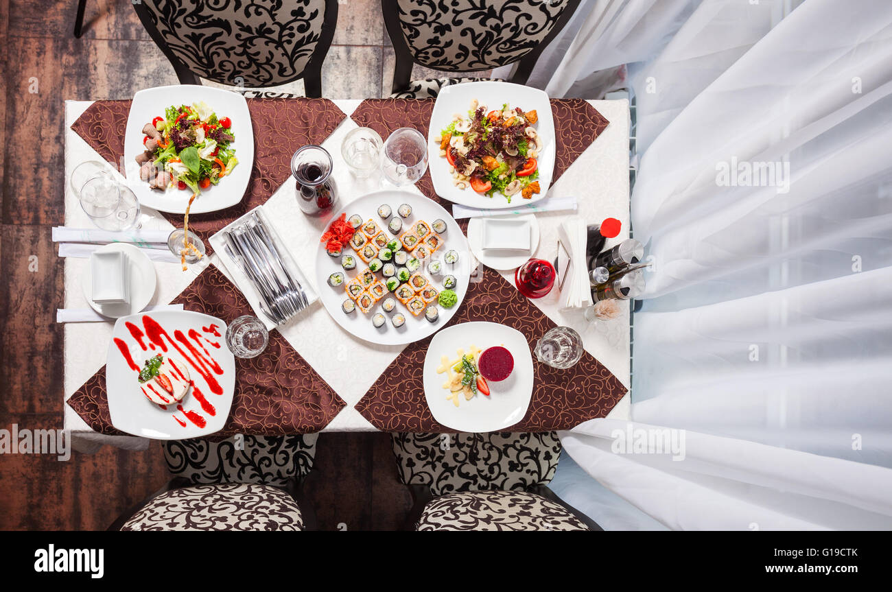 Table at restraurant served for four people Stock Photo - Alamy