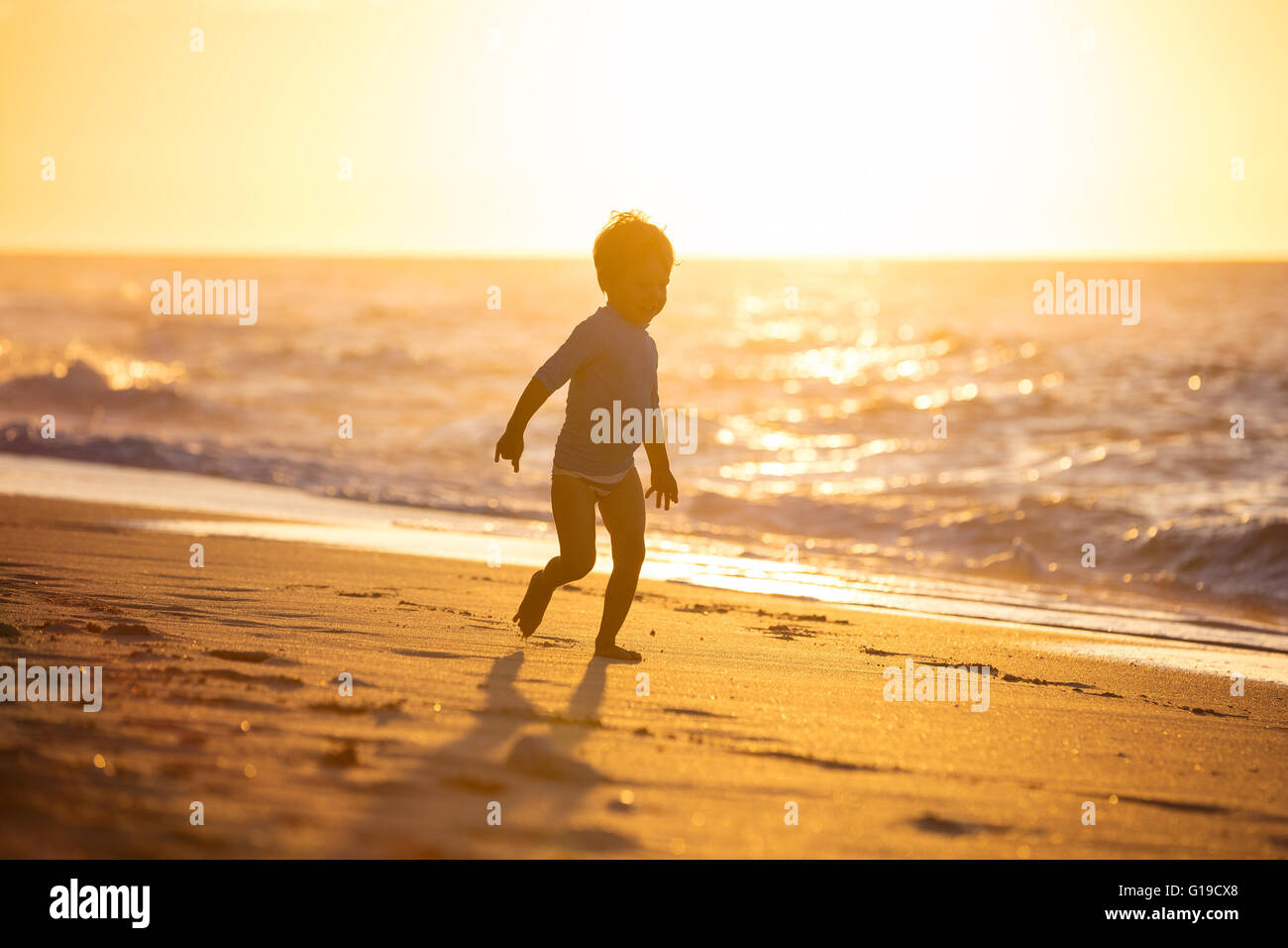 Boy playing at sunset hi-res stock photography and images - Alamy
