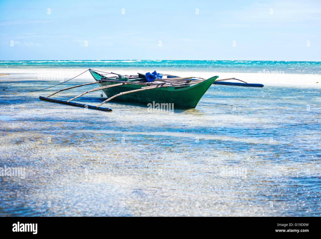 Small asian boat in shallow sea waters Stock Photo - Alamy