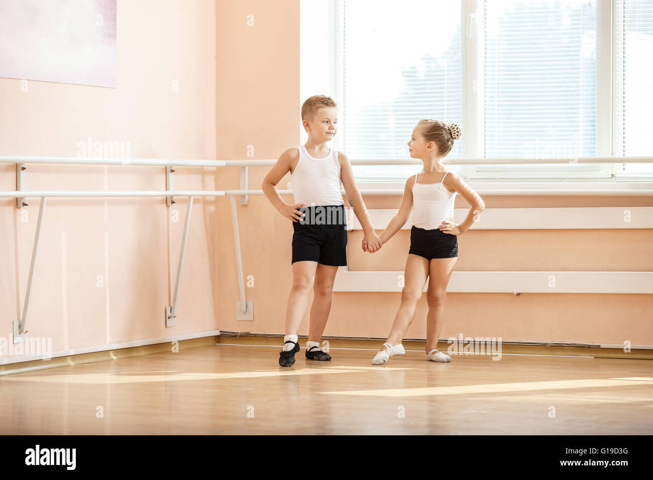 Young dancers doing an exercise while warming up at ballet class Stock ...