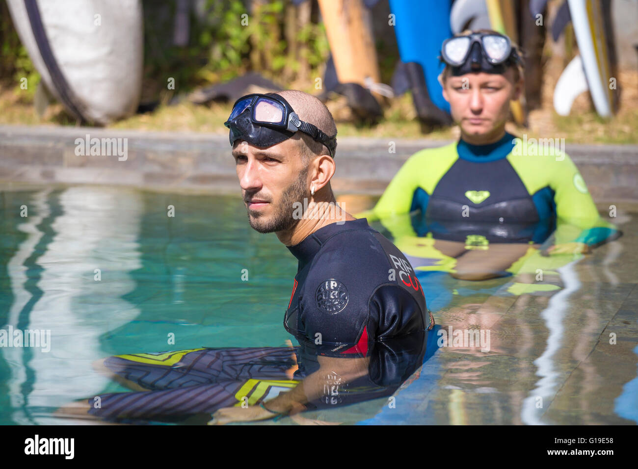 Young couple with dive mask in pool. Freediving training Stock Photo ...