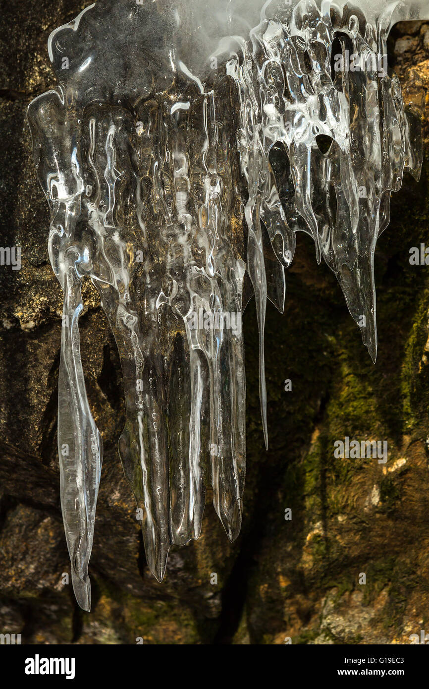 Huge icicles on a cliff Stock Photo - Alamy