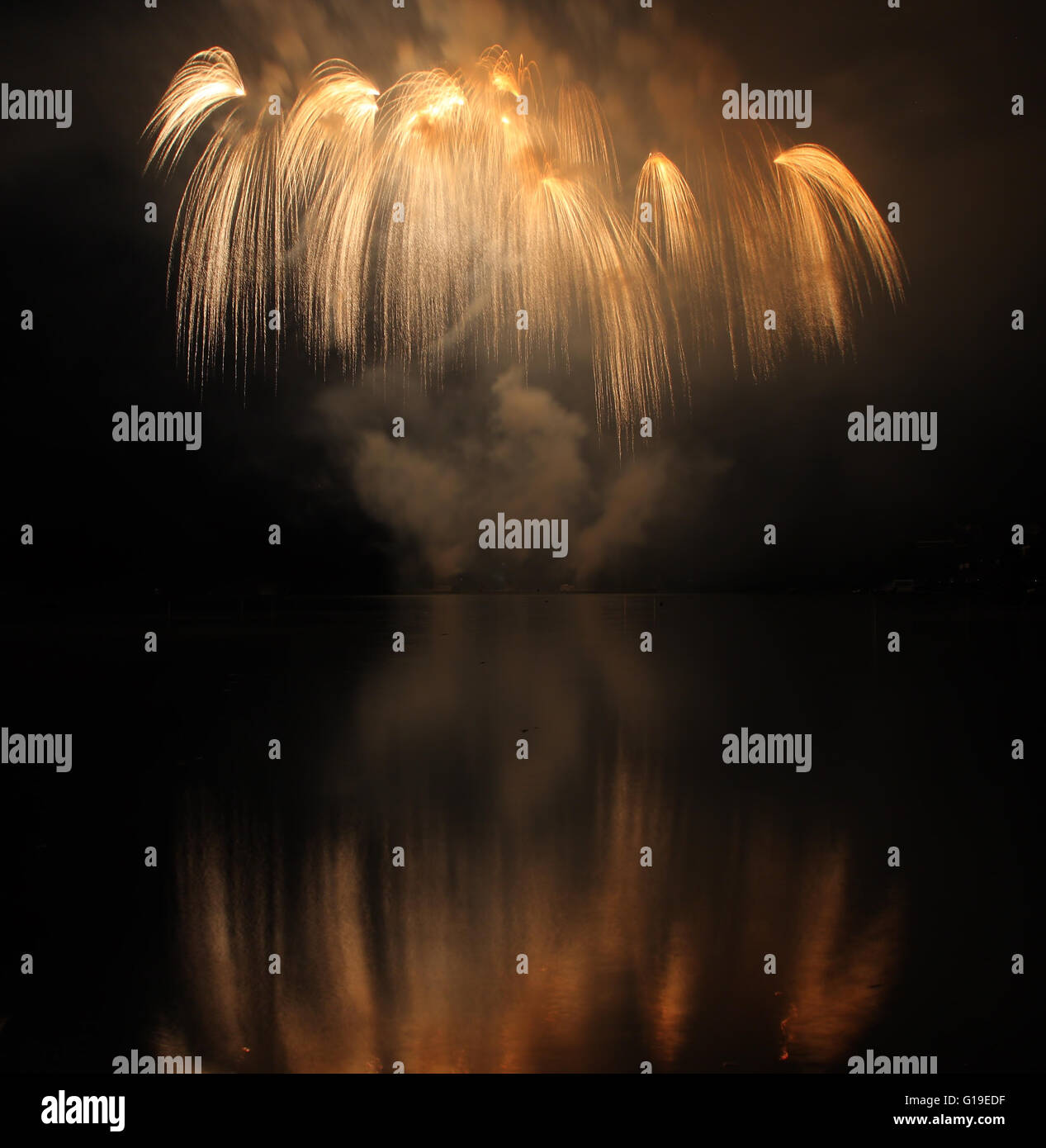 Colorful fireworks with reflection on lake and night sky in background ...