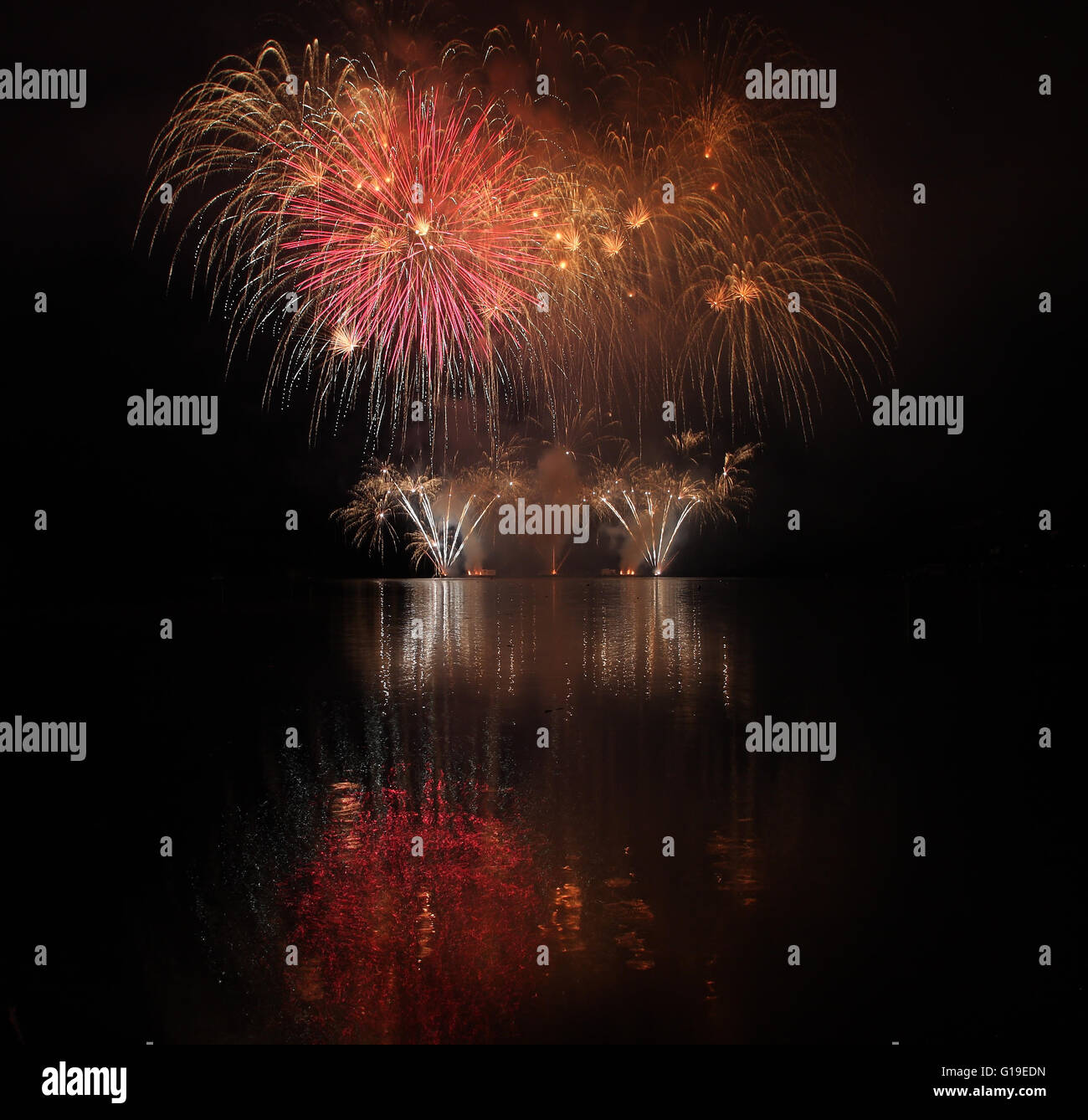 Colorful fireworks with reflection on lake and night sky in background ...