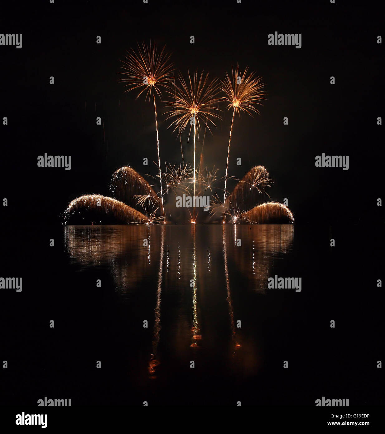 Colorful fireworks with reflection on lake and night sky in background ...